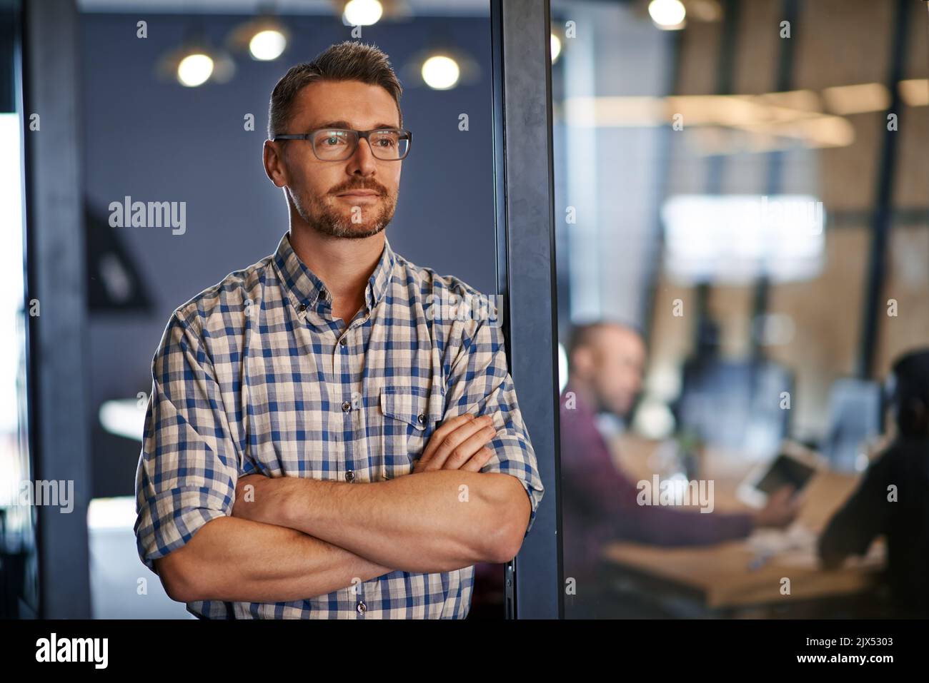 Hes an ideas man. an office worker looking thoughtful Stock Photo - Alamy