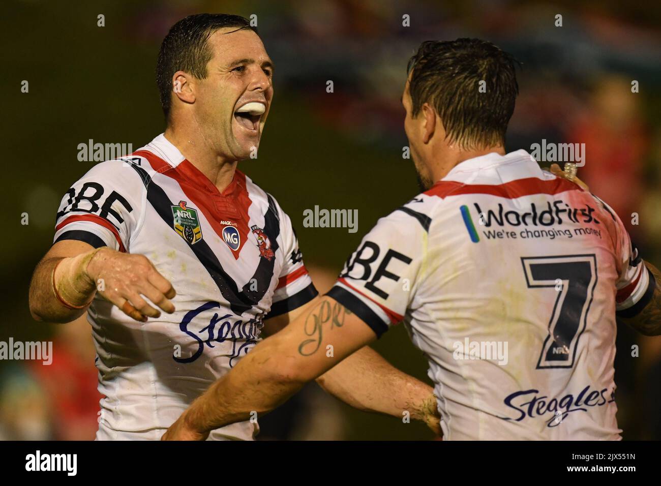 Michael Gordon of the Roosters celebrates his try with Mitchell Pearce ...