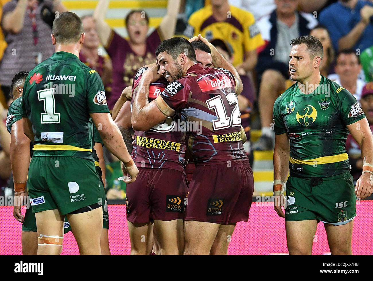 Brisbane Broncos players celebrate a try against the Canberra Raiders ...