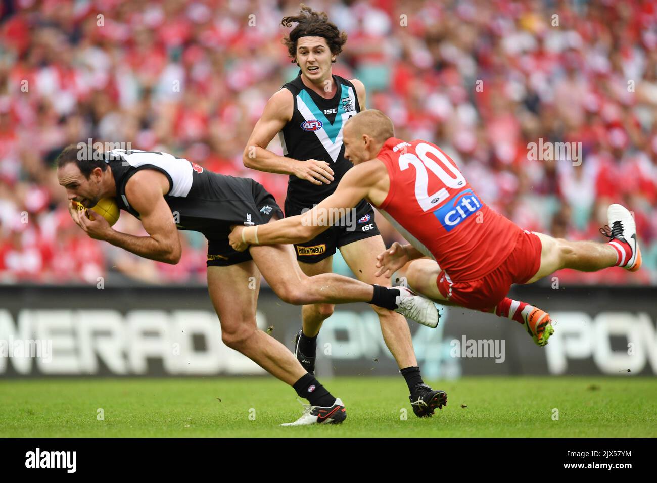 Sam Reid of the Swans tackles Matthew Broadbent of the Power during the ...