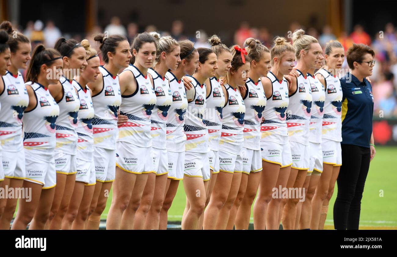 Adelaide Crows players and coach Bec Goddard (right) stand during the ...