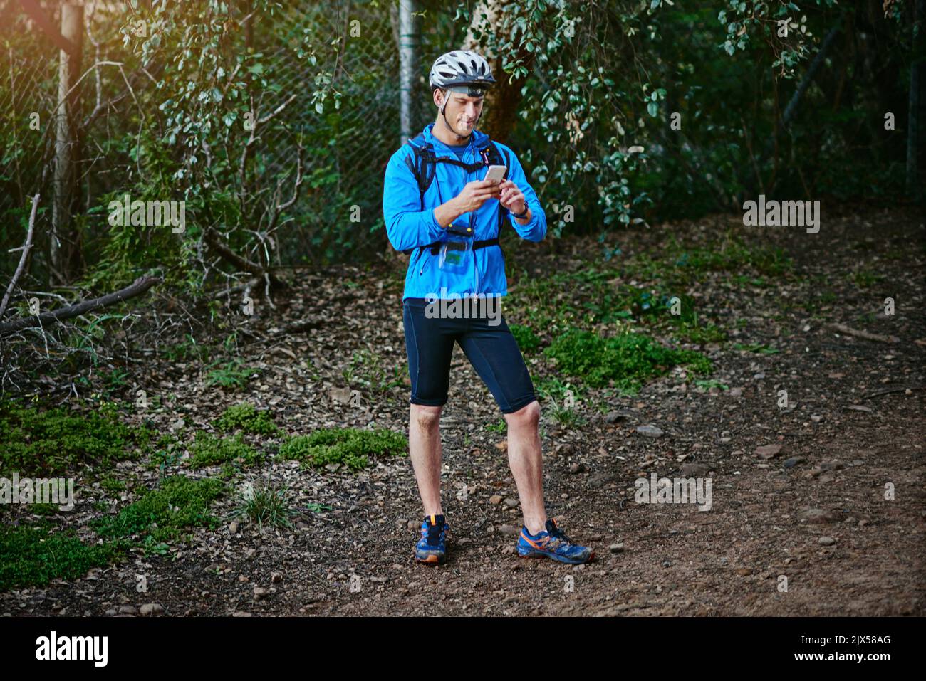 Double-checking the directions. a cyclist using his smartphone while ...