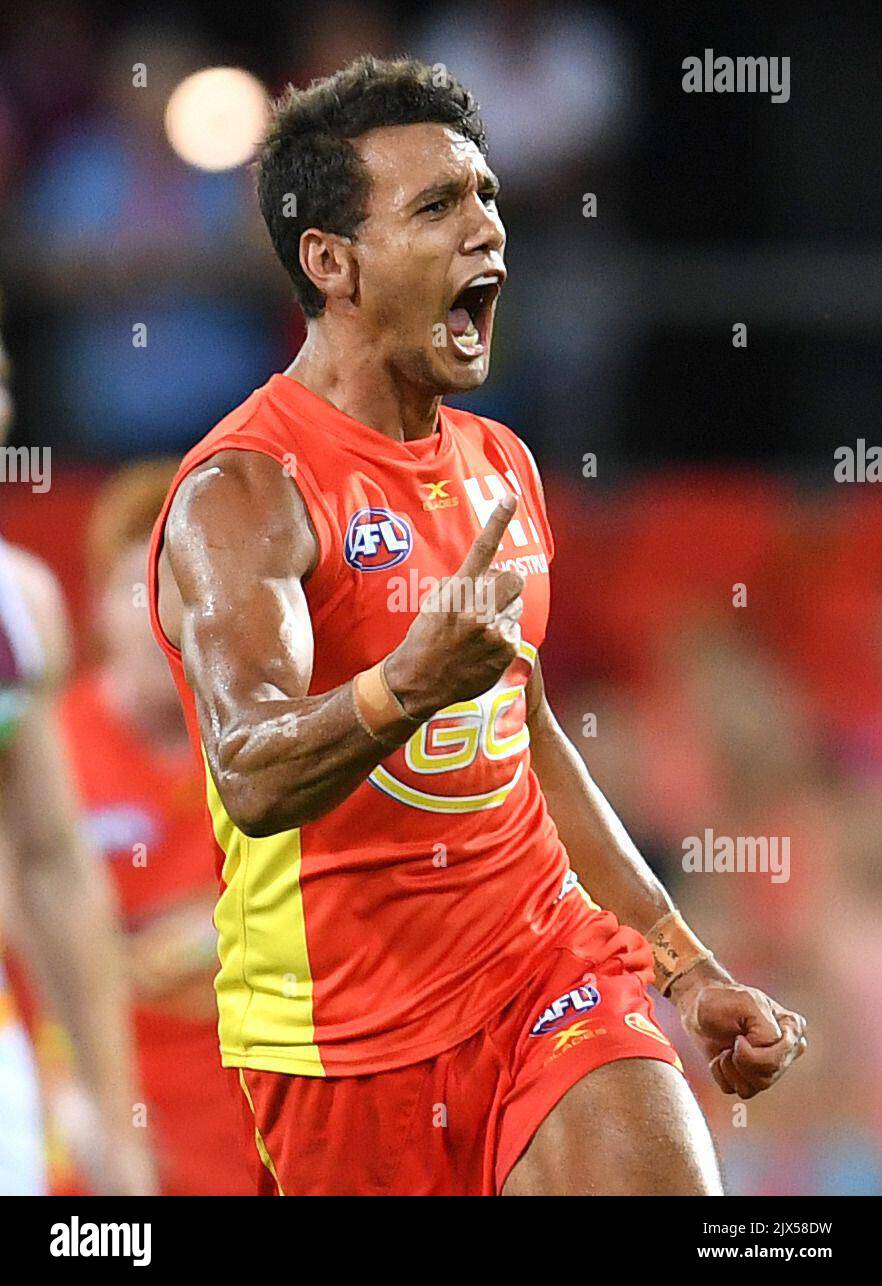 Callum Ah Chee of the Gold Coast Suns celebrates scoring a goal against ...