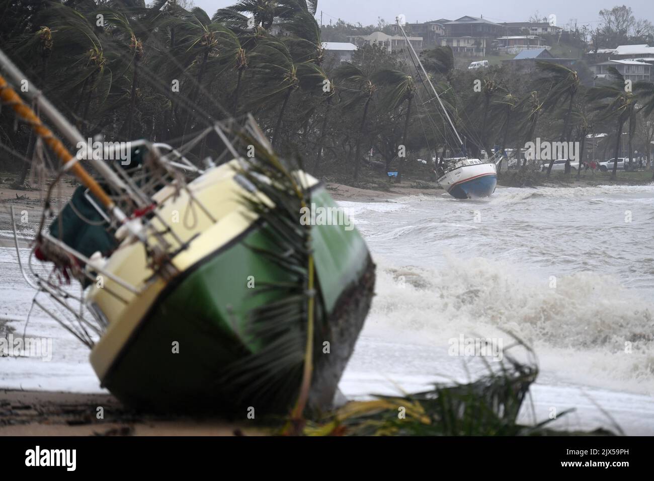 Boats are seen washed ashore at Airlie Beach, Wednesday, March 29, 2017 ...