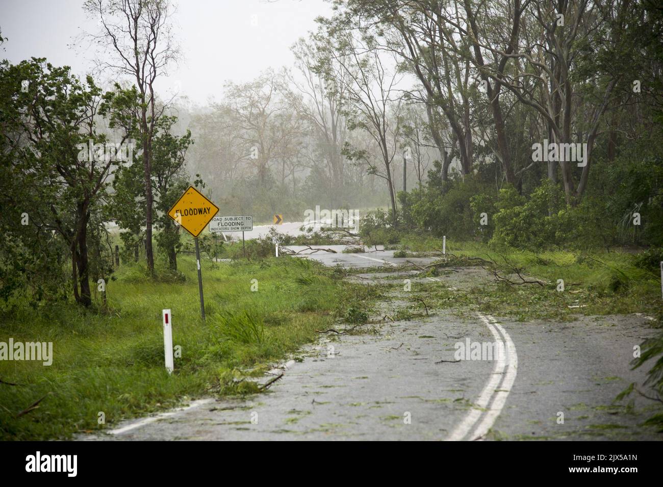 Midge Point Road is Cut by fallen trees and floodway, Wednesday, March ...