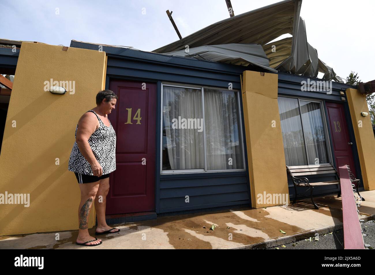 Kerry Campbell inspects damage to her motel in Proserpine, Thursday ...