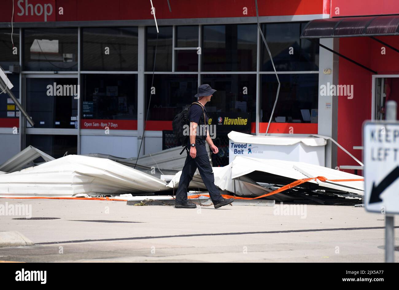 A Fire and Rescue officer inspects damage to a service station in ...