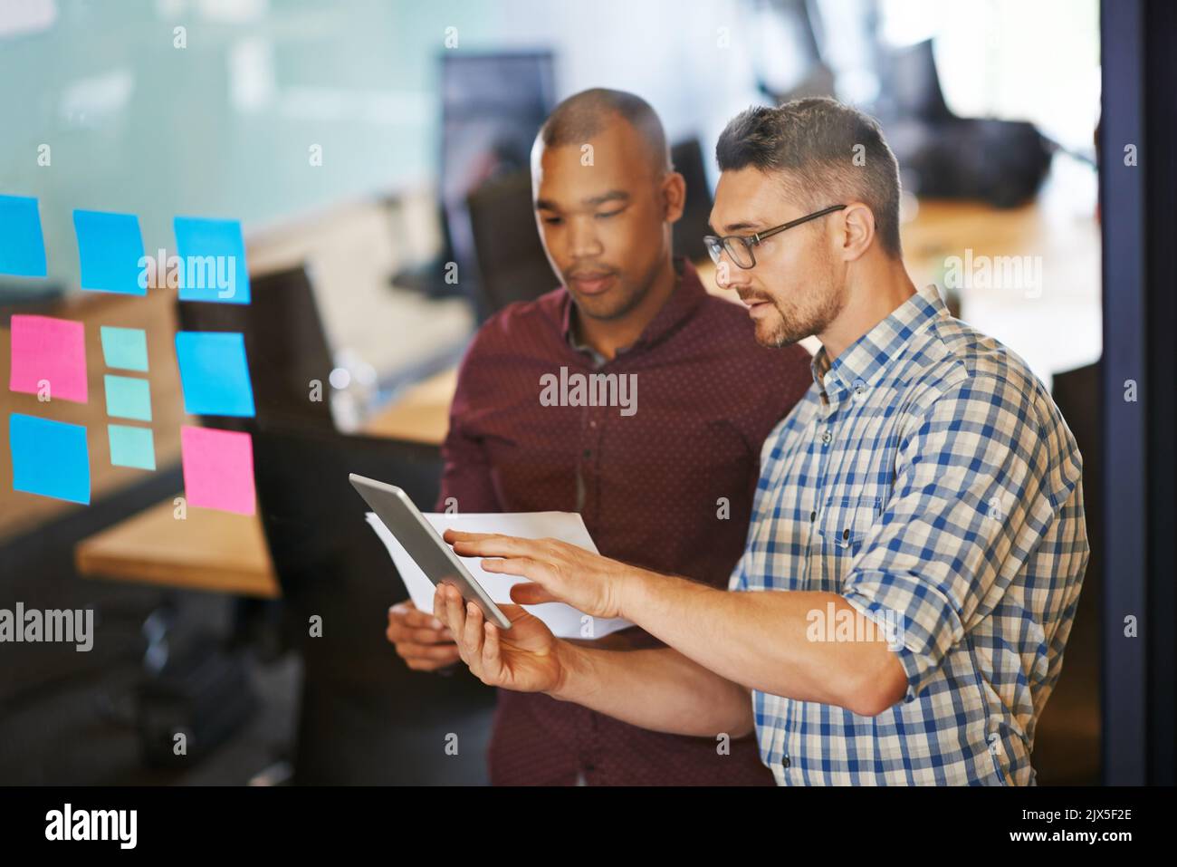 Through hard work, we can improve these designs. two coworkers going ...