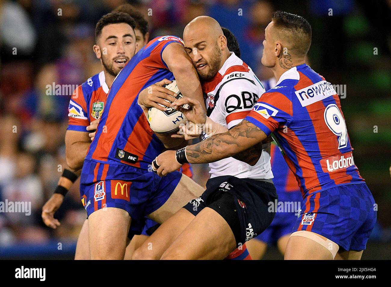 Blake Ferguson of the Roosters is tackled by Joe Wardle, (left), and ...