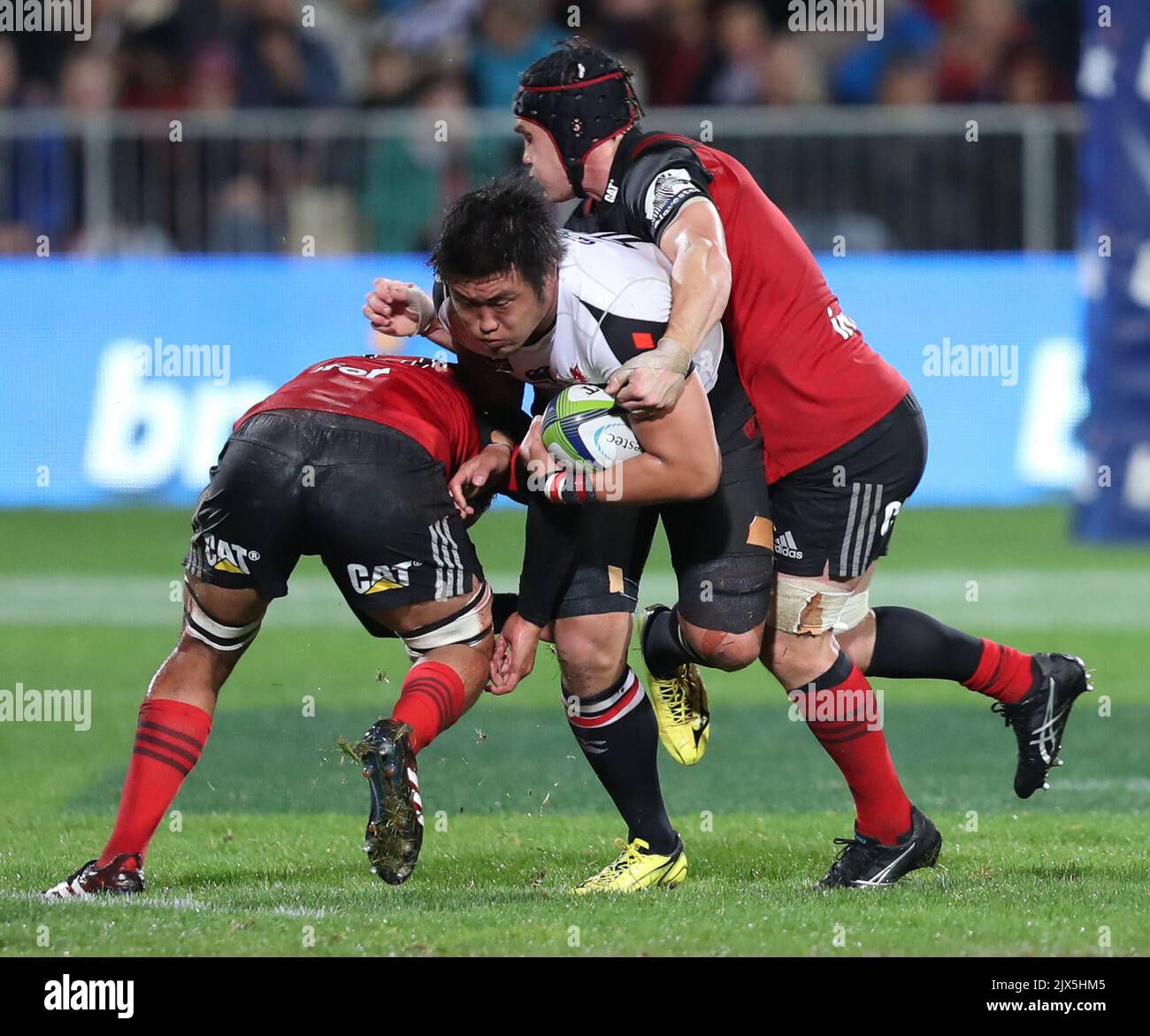 Shinya Makabe of the Sunwolves, centre, makes a run in the Super Rugby ...