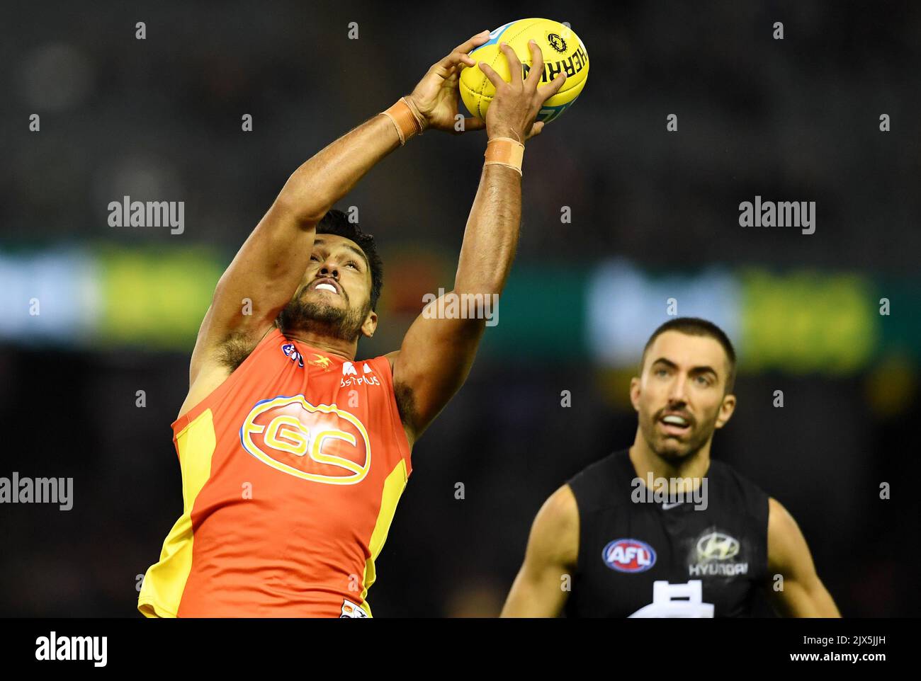 Aaron Hall of the Suns takes a mark during the Carlton Blues and Gold ...