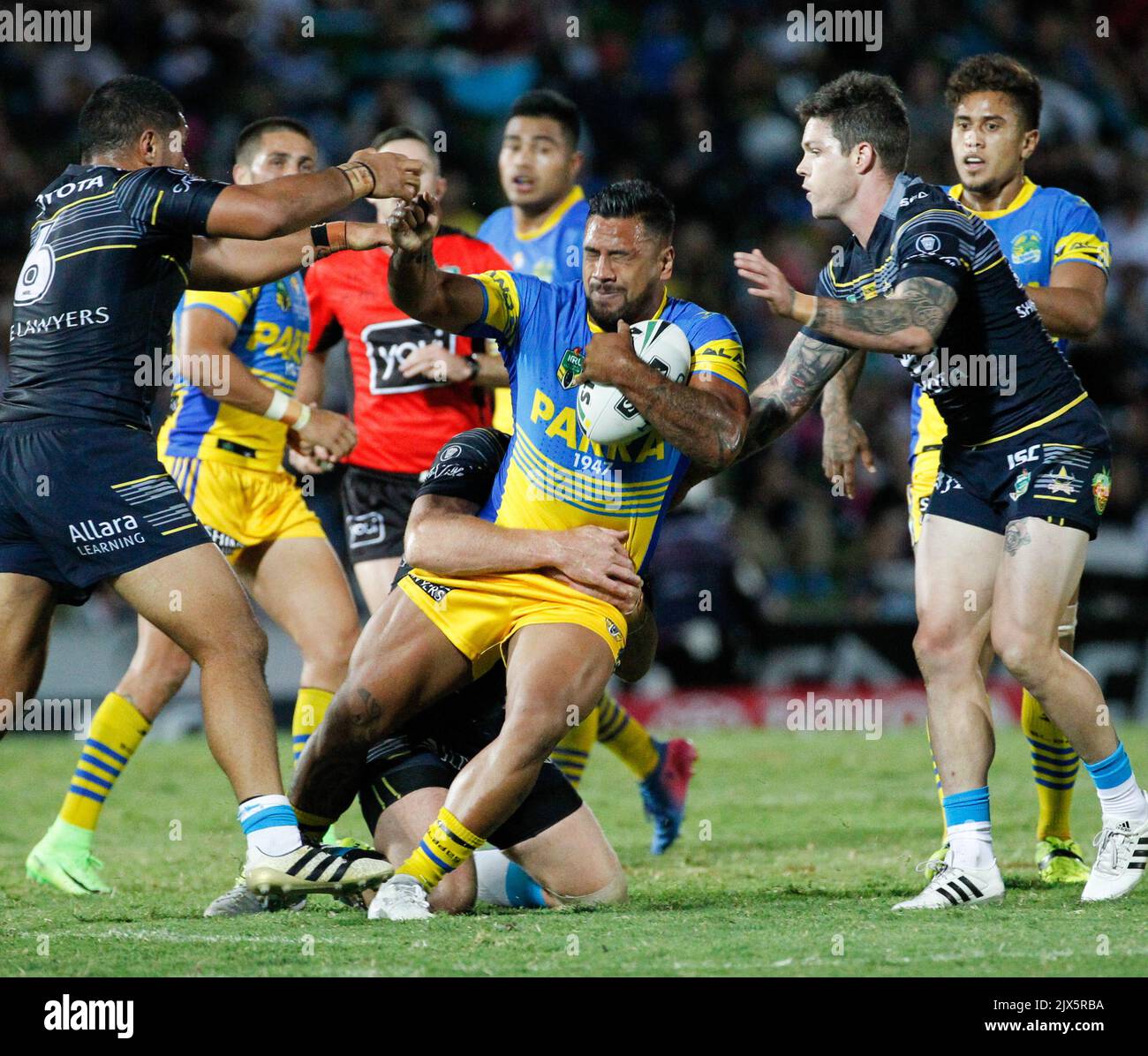 Eels Kenneth Edwards tackled by Cowboys John Asiata, left, and Benjamin Hampton, right, during ...