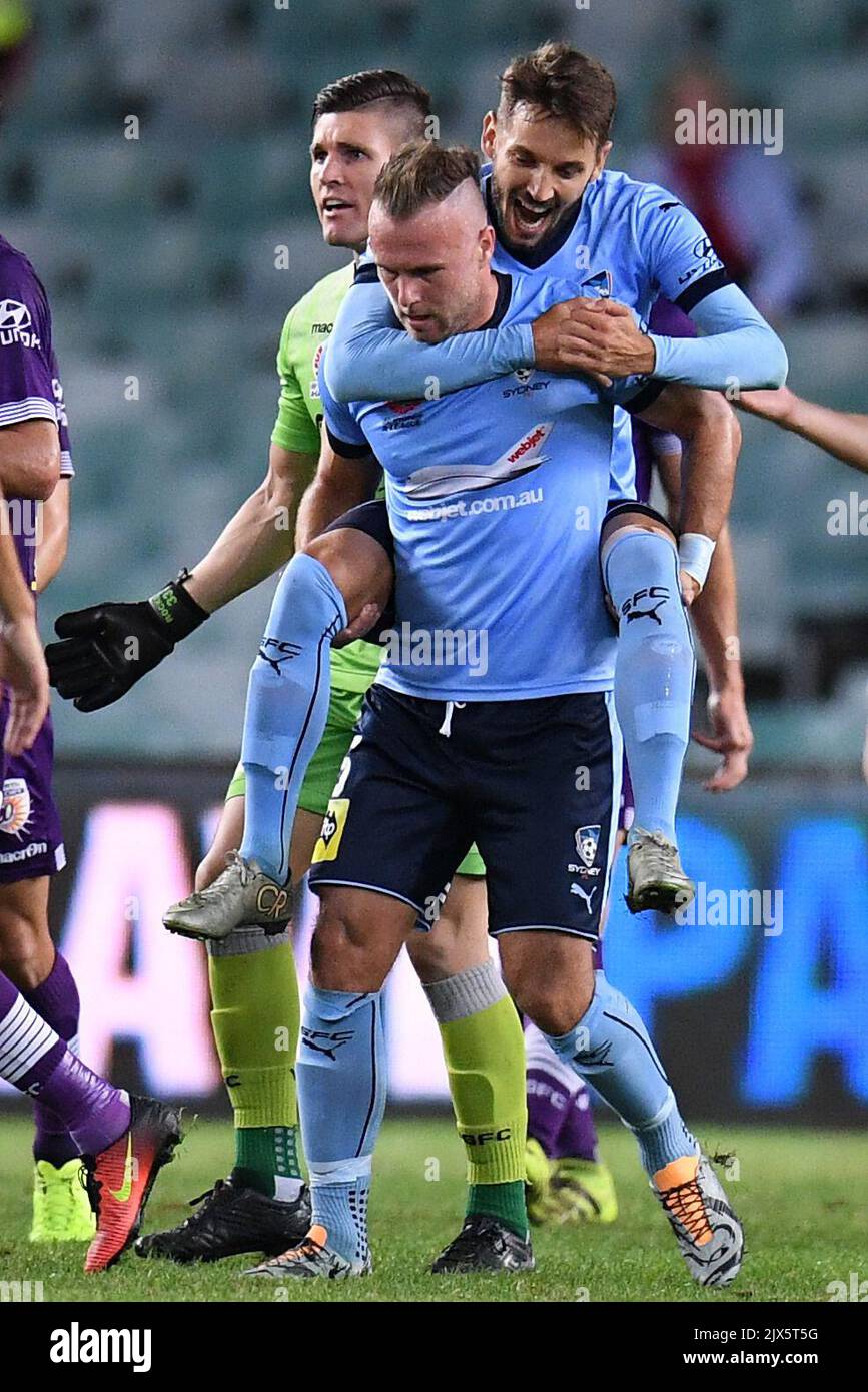 Sydney's Joshua Brilliante jumps on the back of Jordy Buijs as they ...