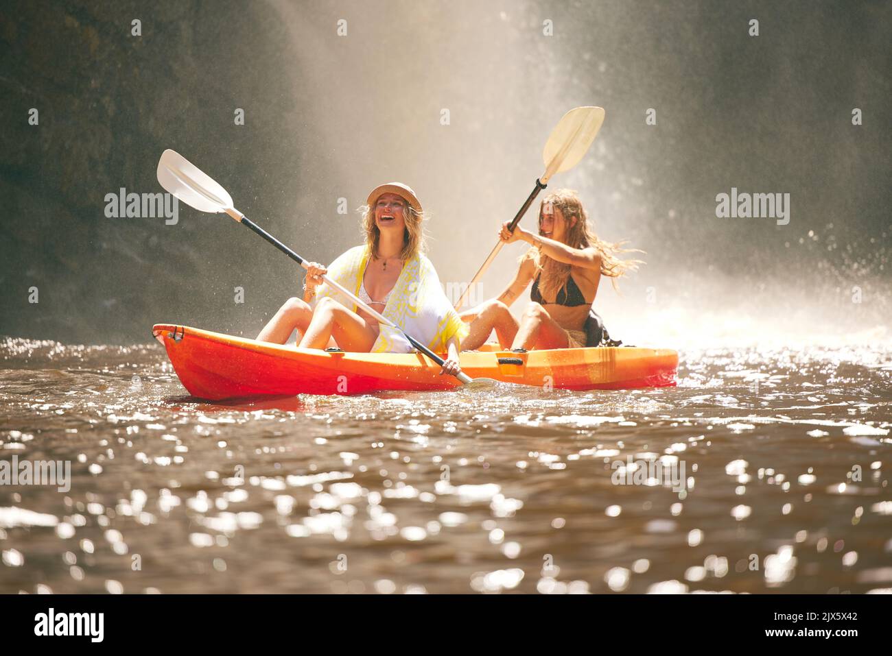 Happy friends kayak on the lake or river together during summer ...