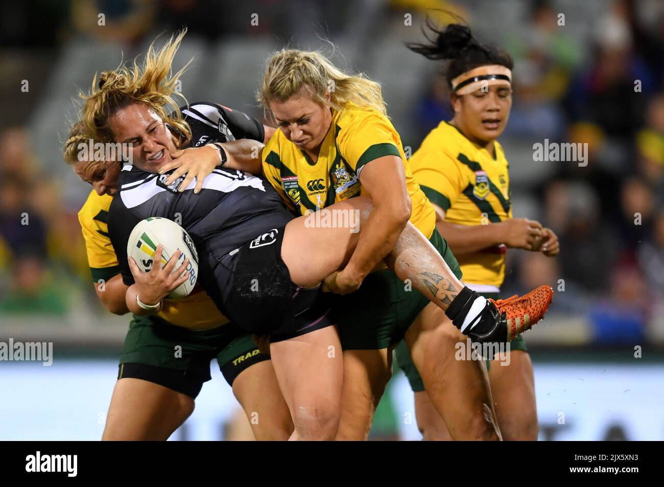 Bunty Kuruwaka-Crowe of the Kiwi Ferns (left) is tackled by Ruan Sims ...