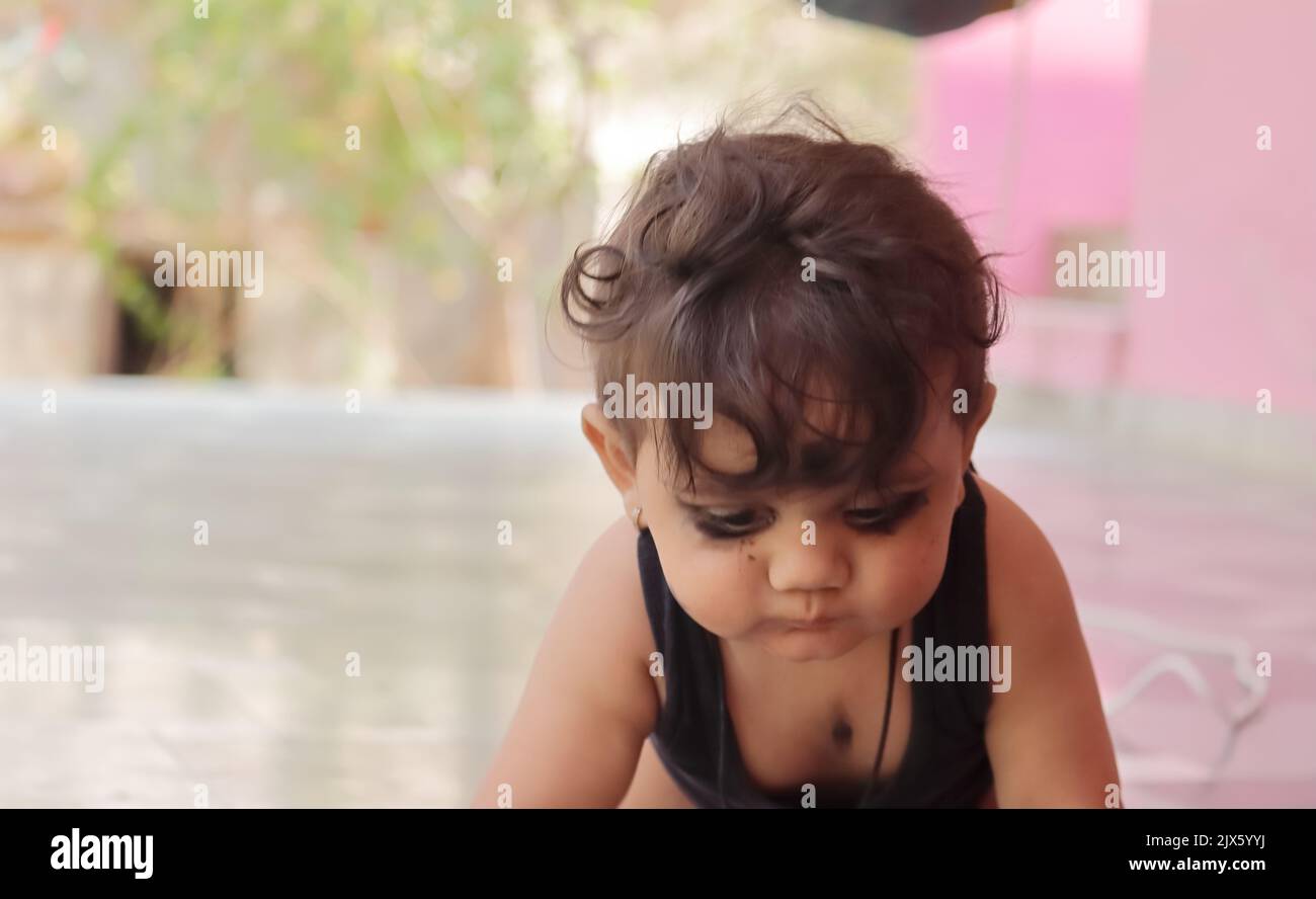 Close-up photo of Playing a small Hindu indian child with a mascara in the eyes Stock Photo - Alamy