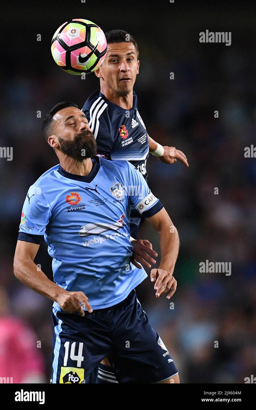 Alex Brosque of Sydney and Daniel Georgievski of the Victory contest a ...