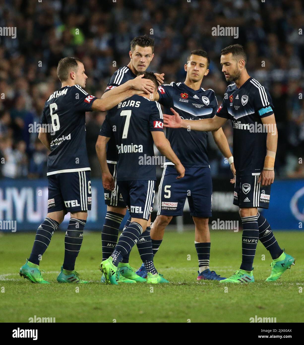 Melbourne Victory players console team mate Marco Rojas (7) after he ...