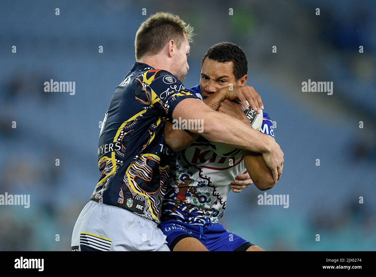 Moses Mbye of the Bulldogs is tackled by Michael Morgan of the Cowboys ...