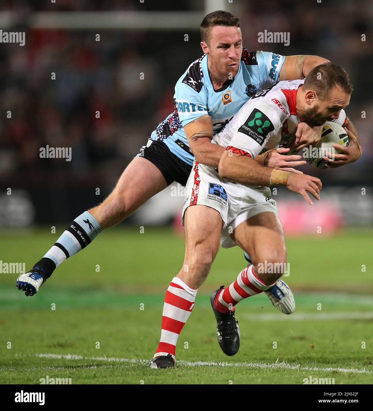 James Maloney of the Sharks tackles Jason Nightingale of the Dragons ...
