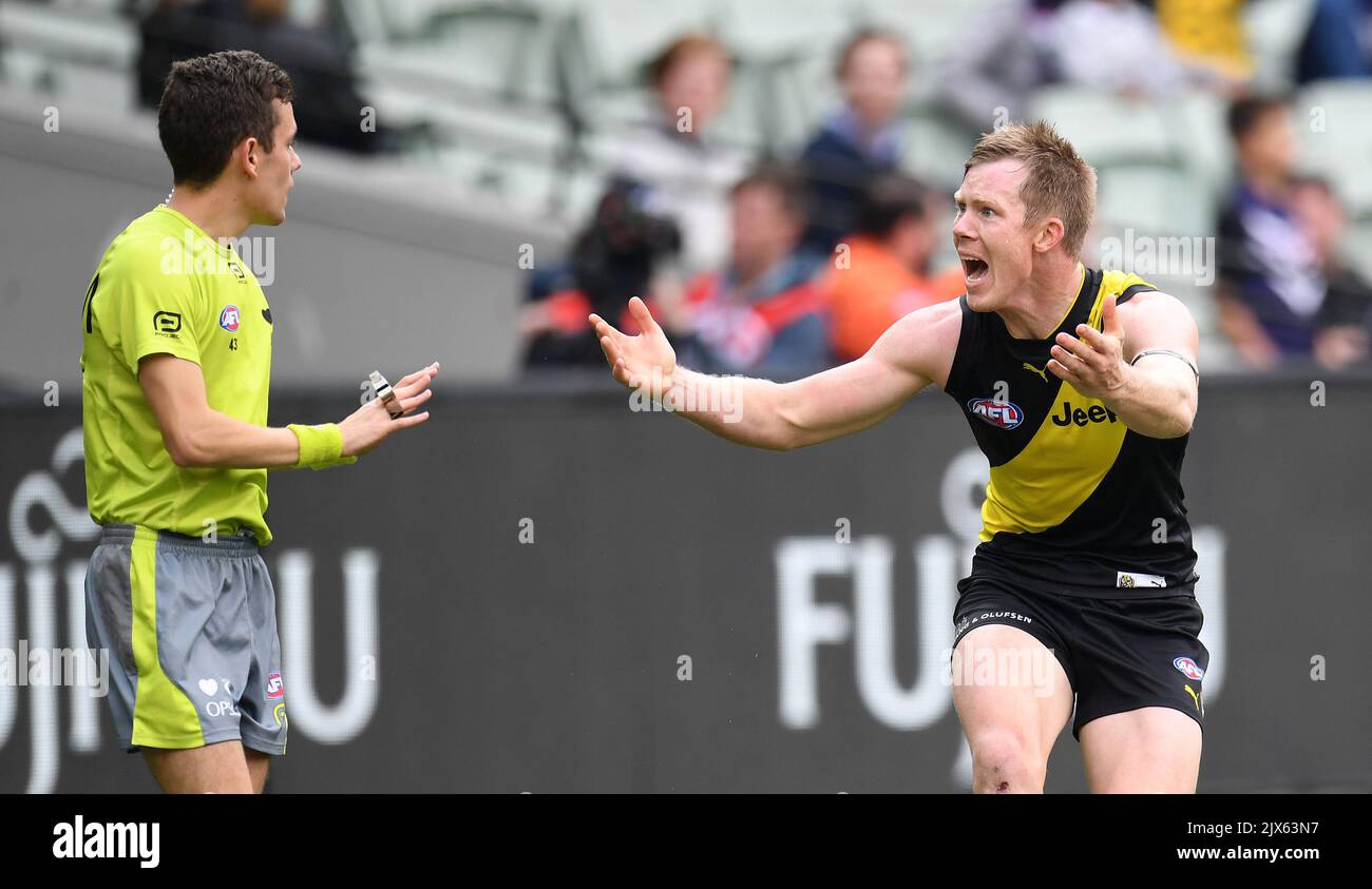Jack Riewoldt of the Tigers (right) reacts to umpire Curtis Deboy during the Round 8 AFL match ...