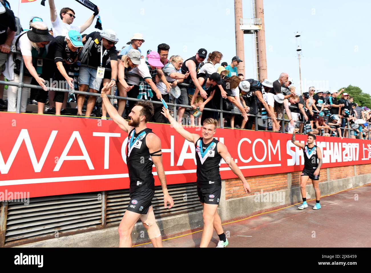 Port players celebrate their win with fans after the round 8 AFL match ...