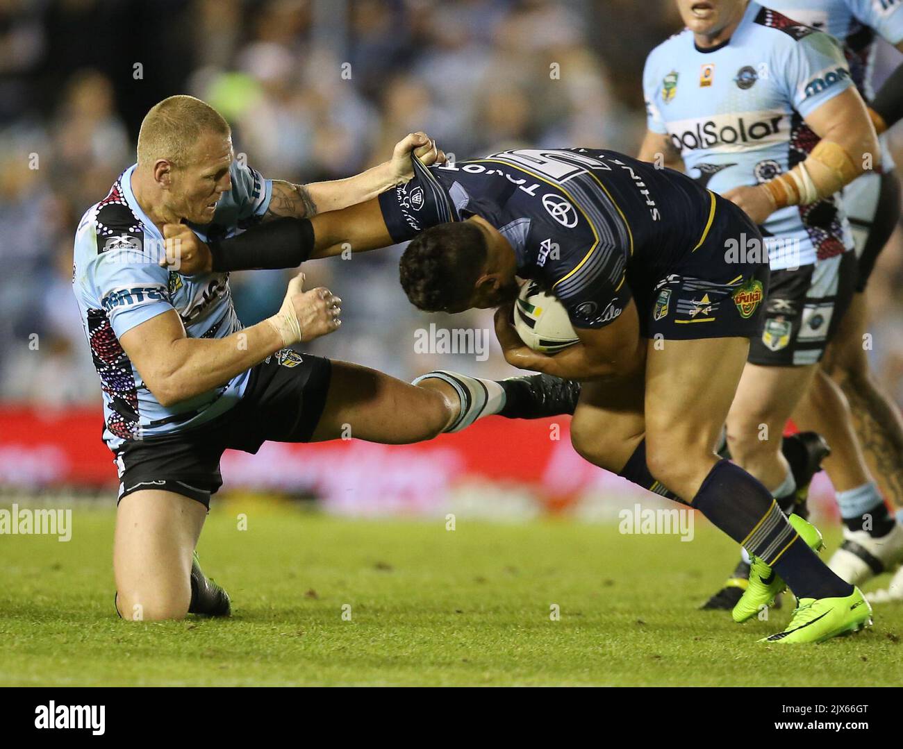Luke Lewis of the Sharks tackles Antonio Winterstein of the Cowboys ...