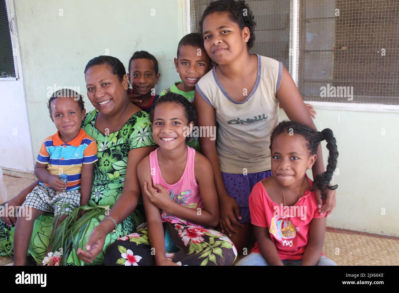 A Fijian woman and her six children outside their home in Korovuto ...