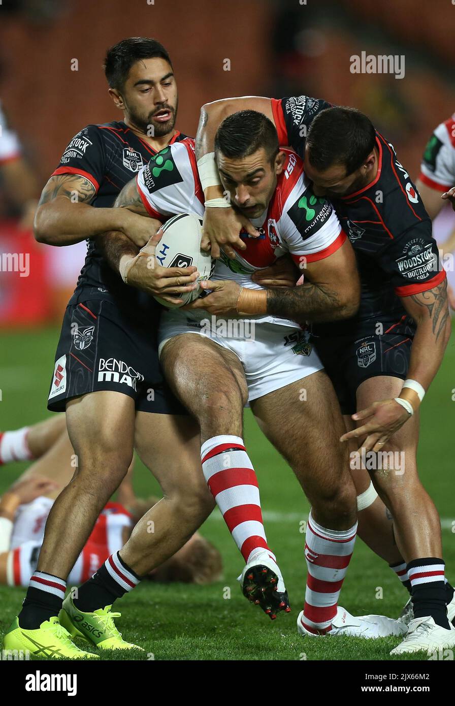 Paul Vaughan of the Dragons is tackled by Shaun Johnson, left, and ...