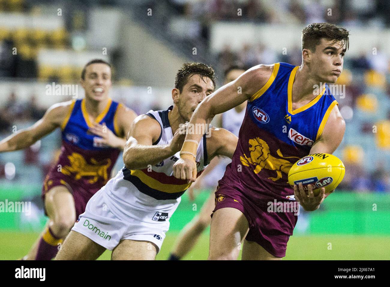 Ben Keays of the Lions (right) attempts to hand ball during the Round 9 ...