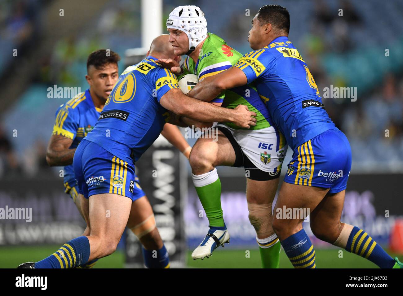 Tim Mannah and Kirisome Auva'a of the Eels tackle Jarrod Croker of the ...