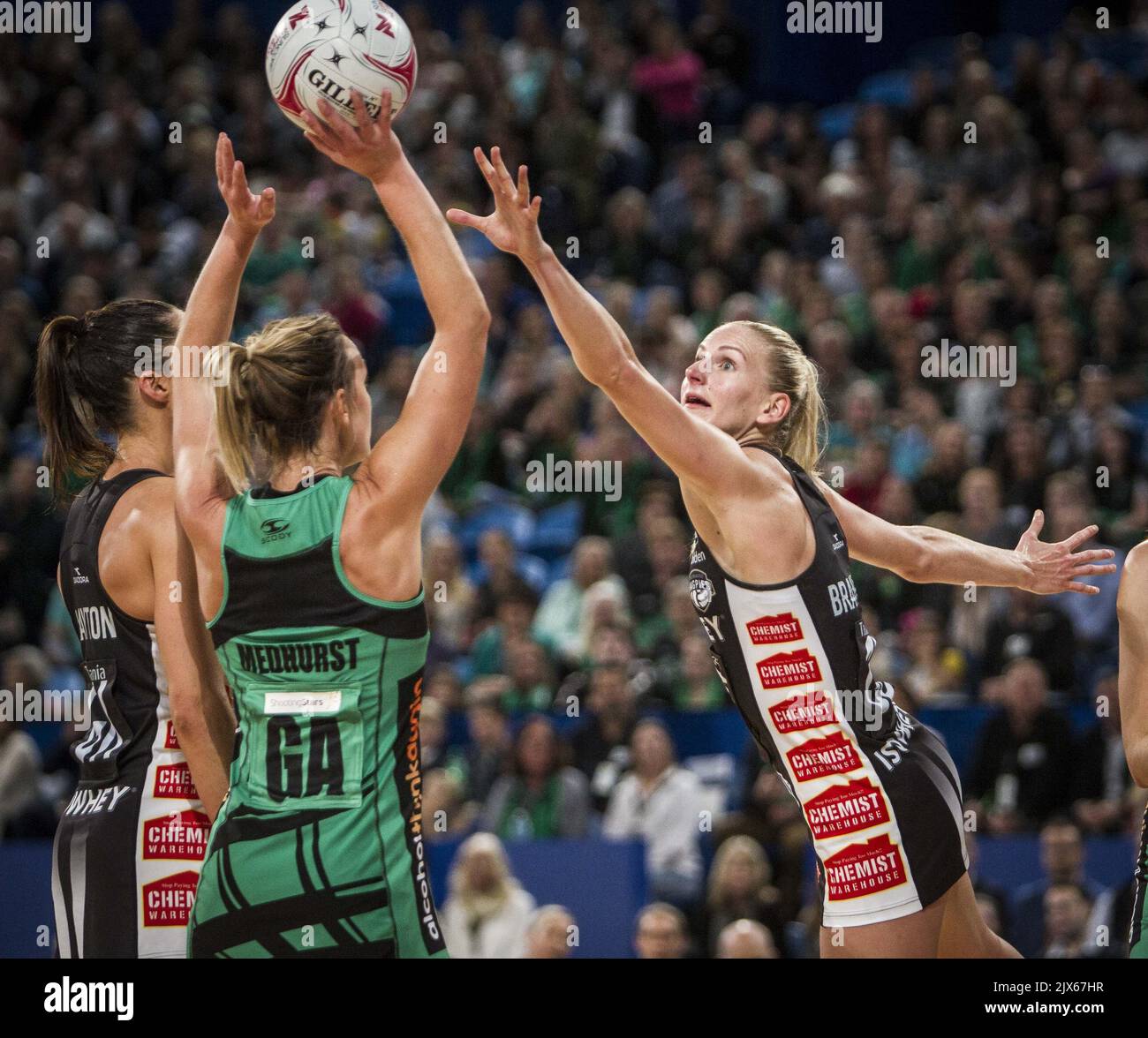 Natalie Medhurst of the Fever (left) shoots as April Brandley of the ...