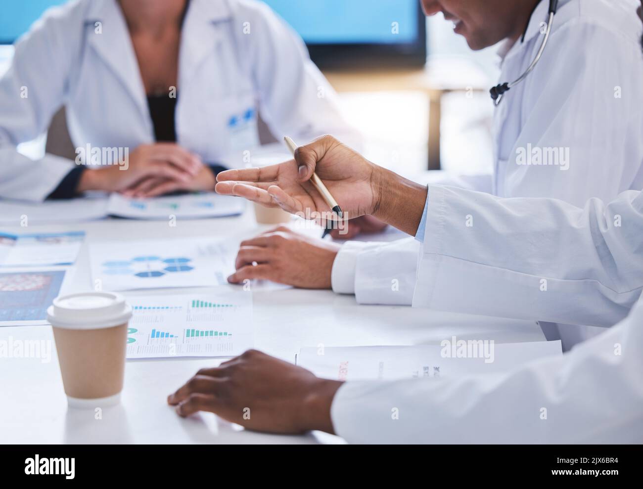 Hospital staff discuss paper hi-res stock photography and images - Alamy