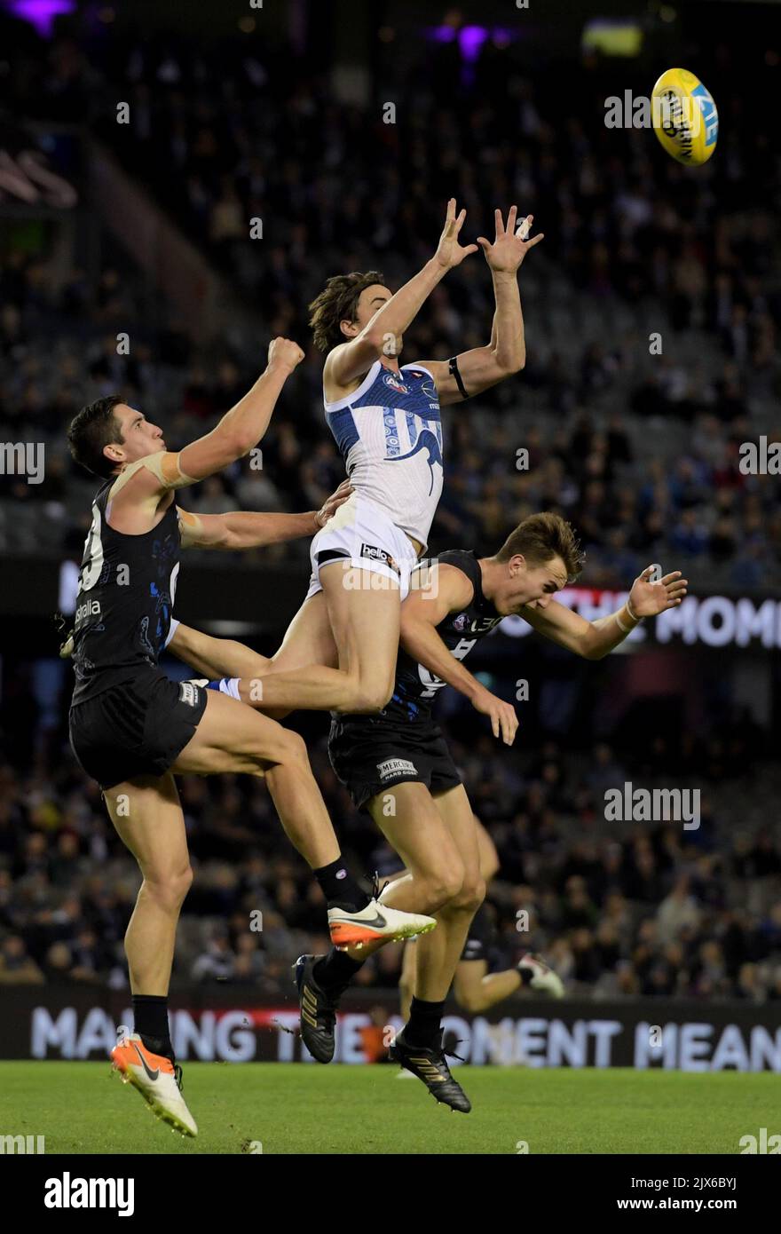 Taylor Garner of the Kangaroos takes a mark over Jacob Weitering of the ...