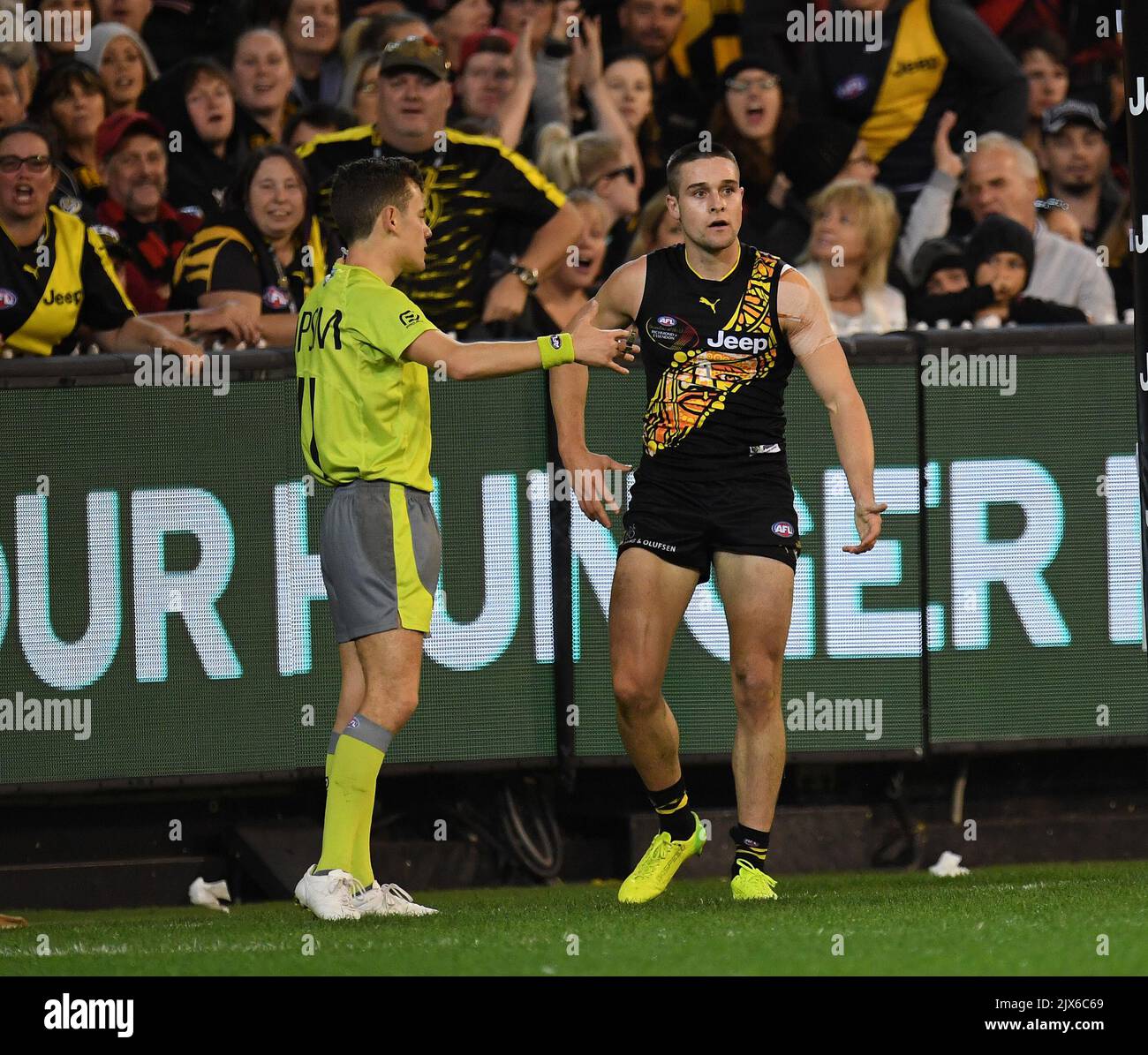 Jayden Short of the Tigers (right) and umpire Curtis DeBoy are seen ...
