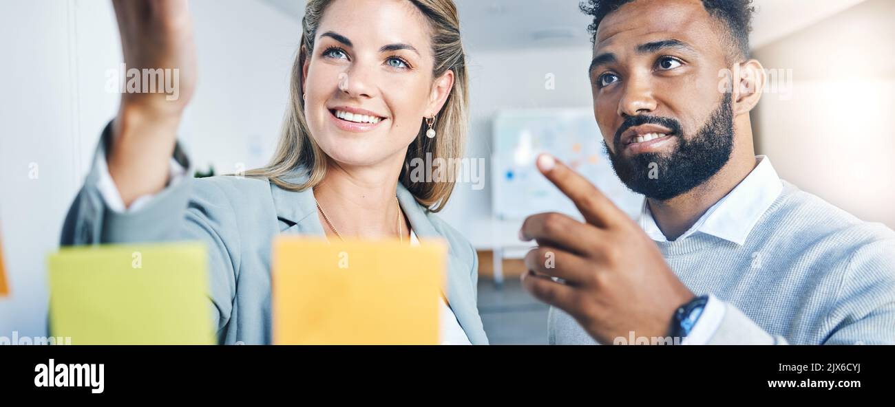 Business team, planning and innovation with post it notes on glass wall ...