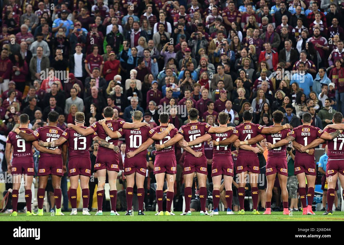 Queensland Maroons players stand as the national anthem is sung at the ...