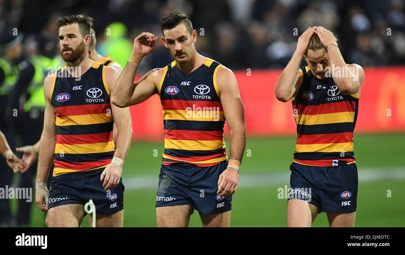 Taylor Walker (centre) and Rory Sloane (right) of the Crows leave the ...