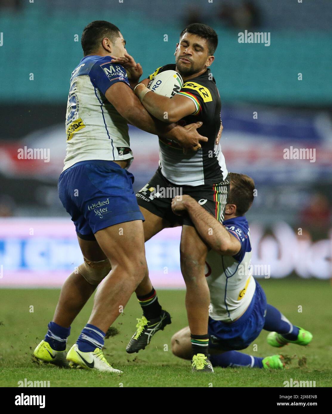 Tyrone Peachey of the Panthers (centre) is tackled by Danny Fualalo of ...