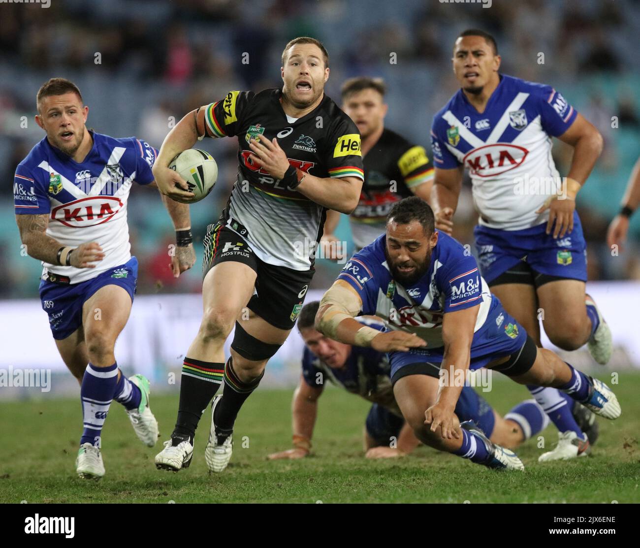Trent Merrin of the Panthers (centre) makes a break during the Round 13 ...