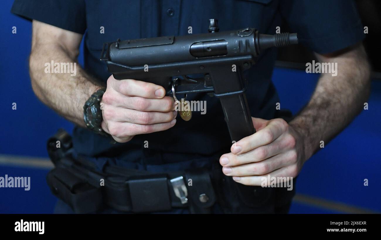 A Leading Senior Constable handles a TECH-9 Semi-automatic pistol at ...
