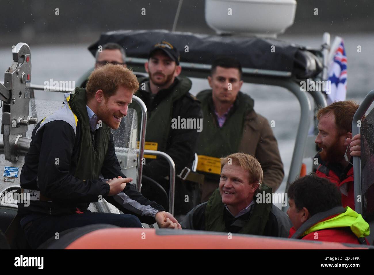 His Royal Highness Prince Harry chats with sailors during a sailing ...