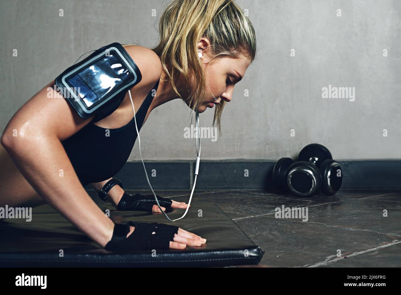 Perseverance means never giving up. a young woman doing push ups Stock ...