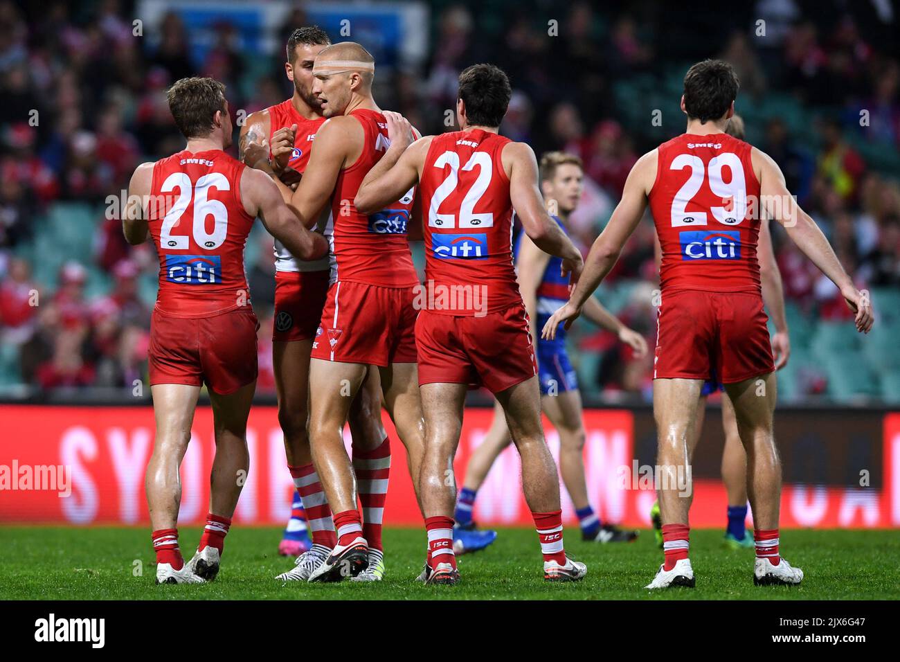 Sam Reid (centre) of the Swans is congratulated after kicking a goal ...