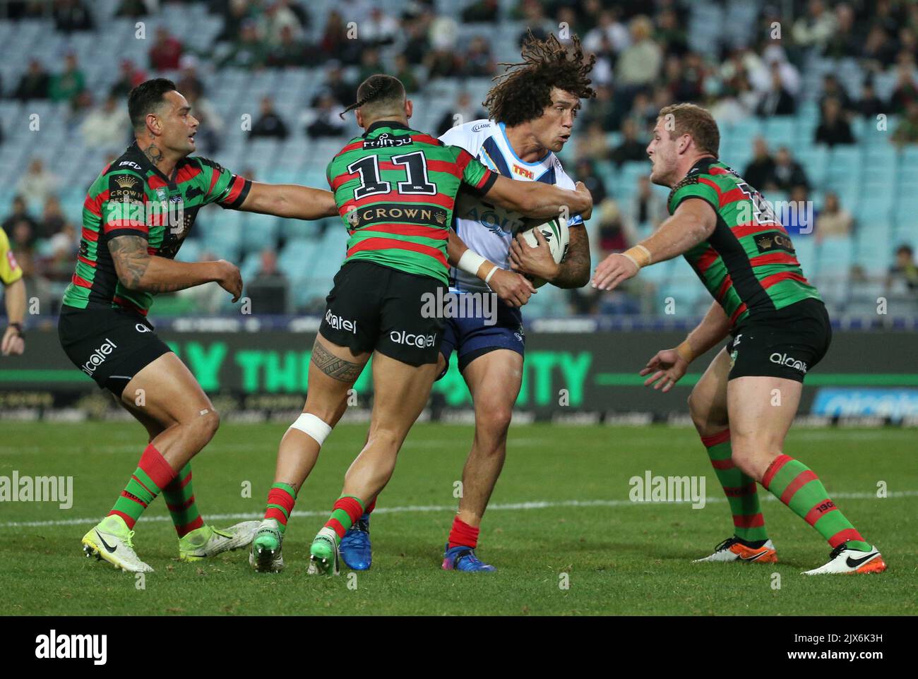 Kevin Proctor of the Titans runs with the ball into the Rabbitohs ...