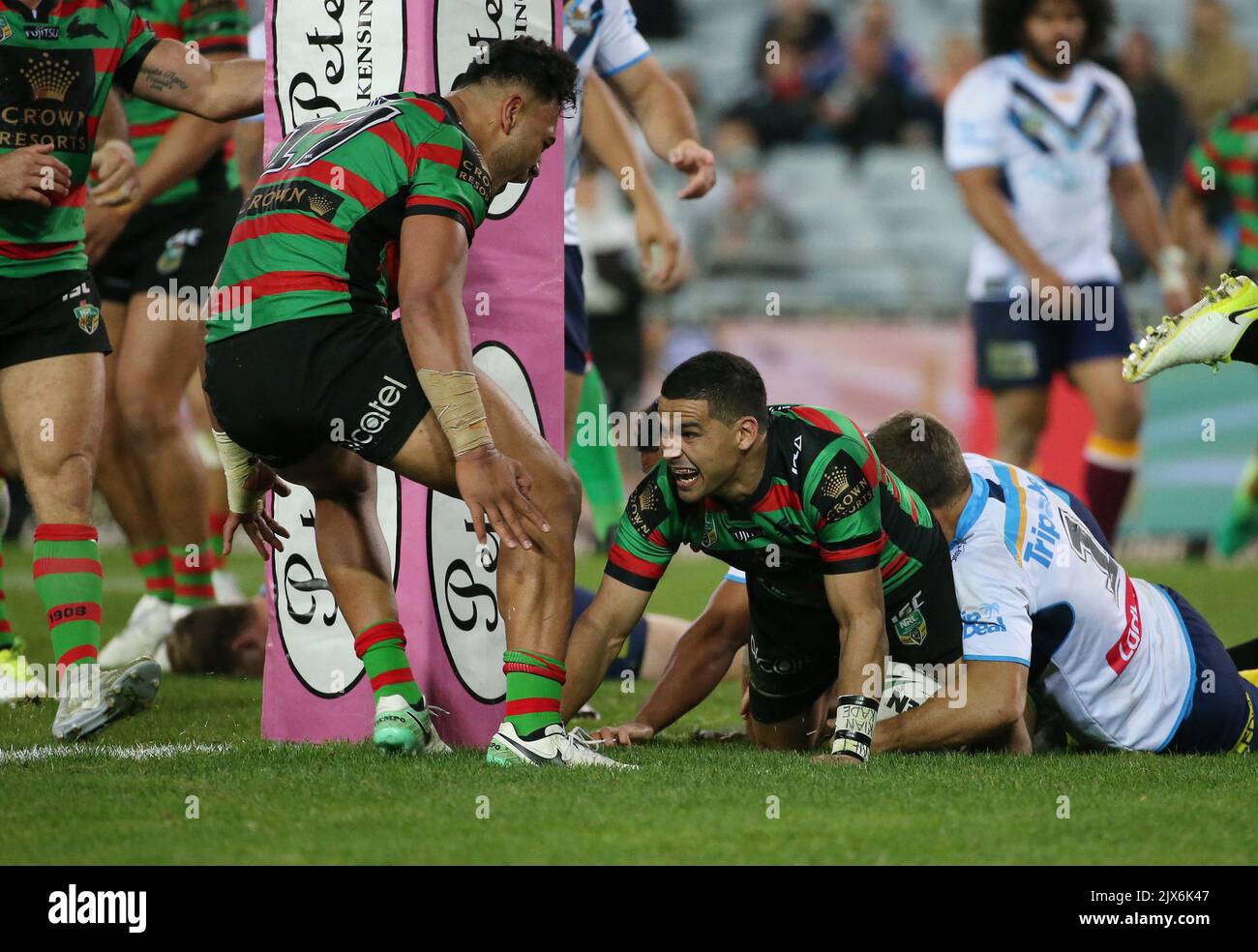 Cody Walker of the Rabbitohs (centre) reacts after scoring a try during ...