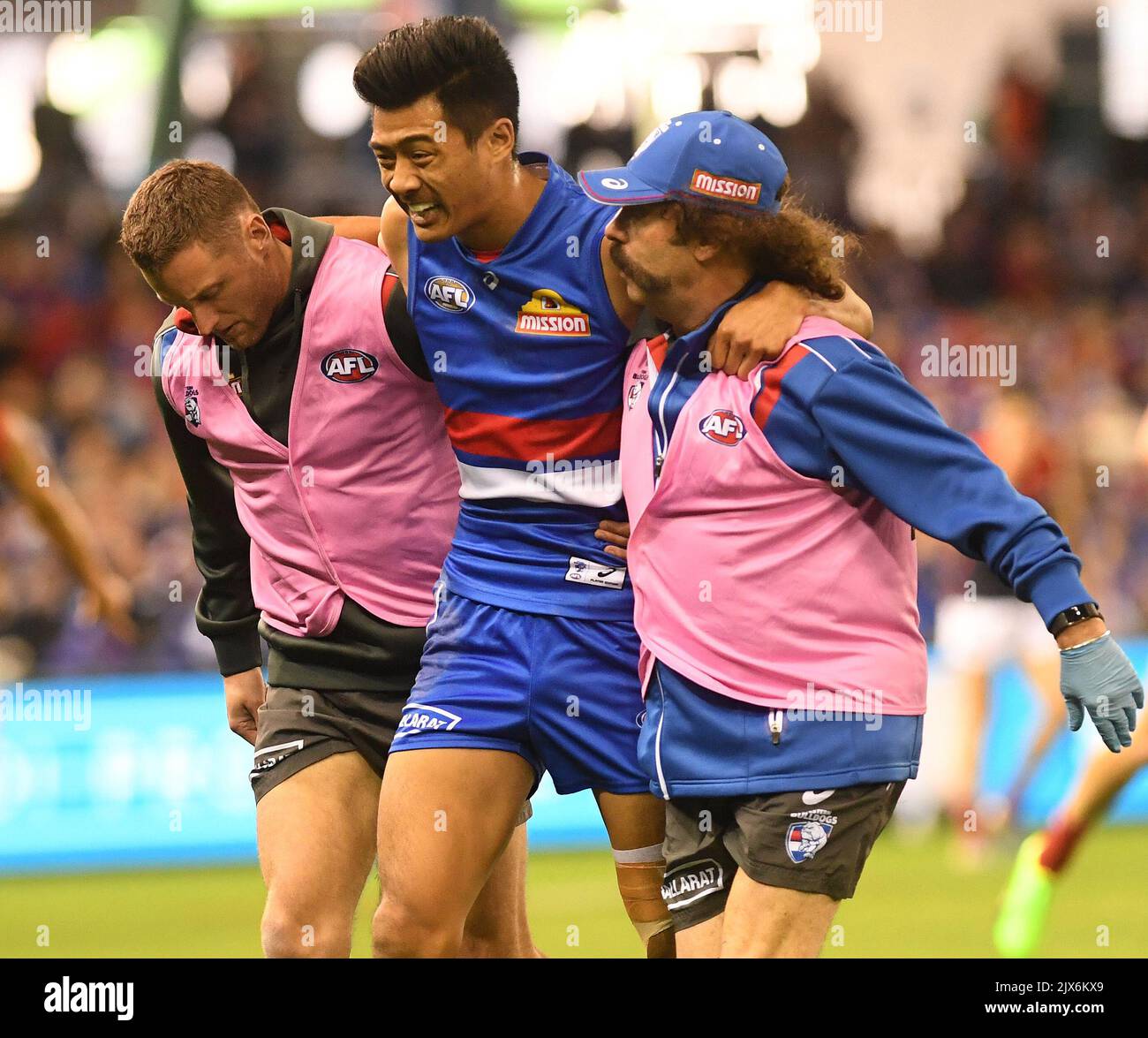 Lin Jong of the Bulldogs (centre) is seen after sustaining an injuy ...