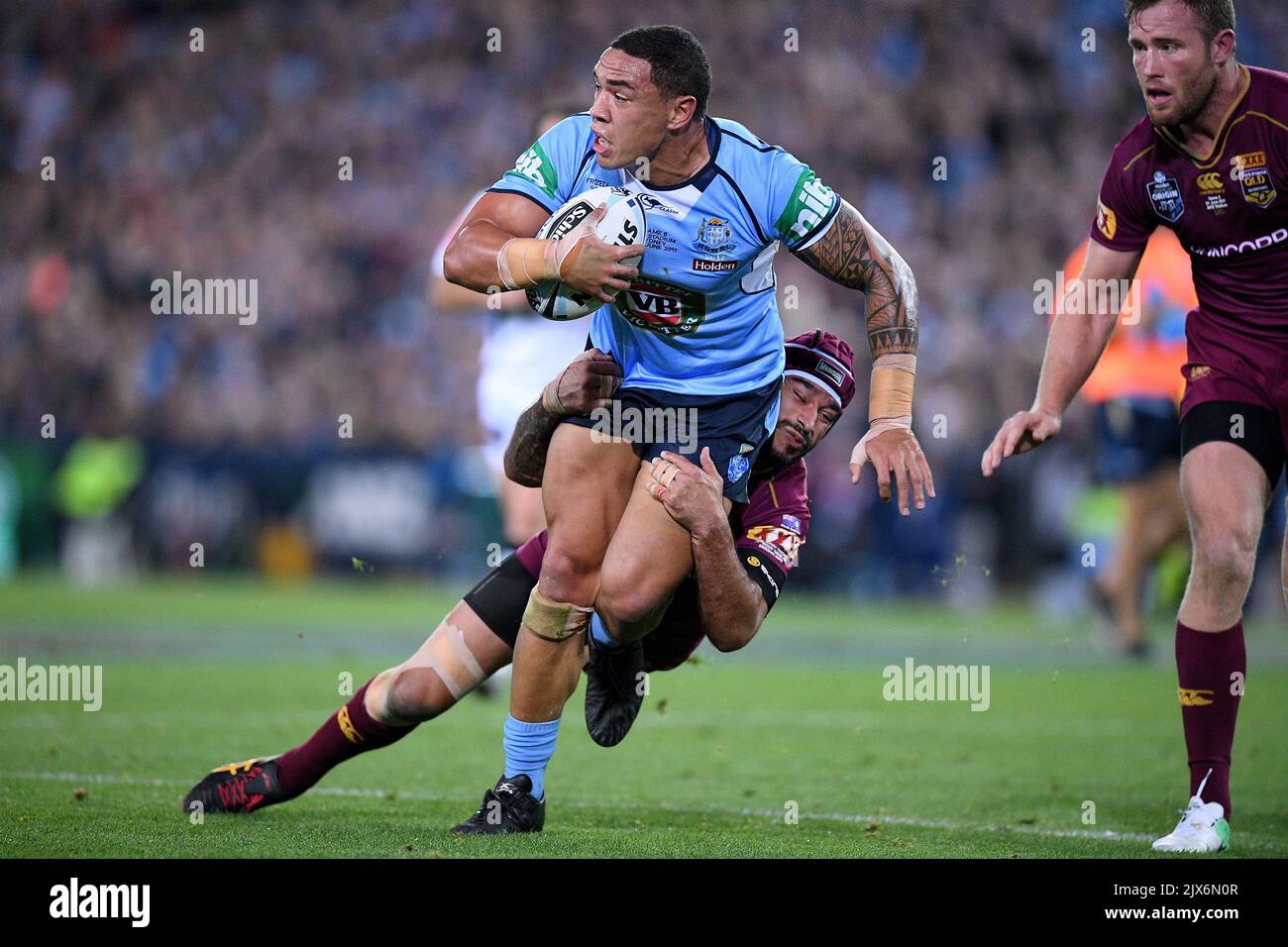 Tyson Frizell of the Blues is tackled by Johnathan Thurston of the ...