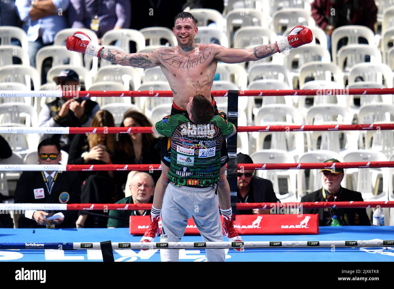 Australia's Damien Hooper is lifted by his trainer after his WBO and ...