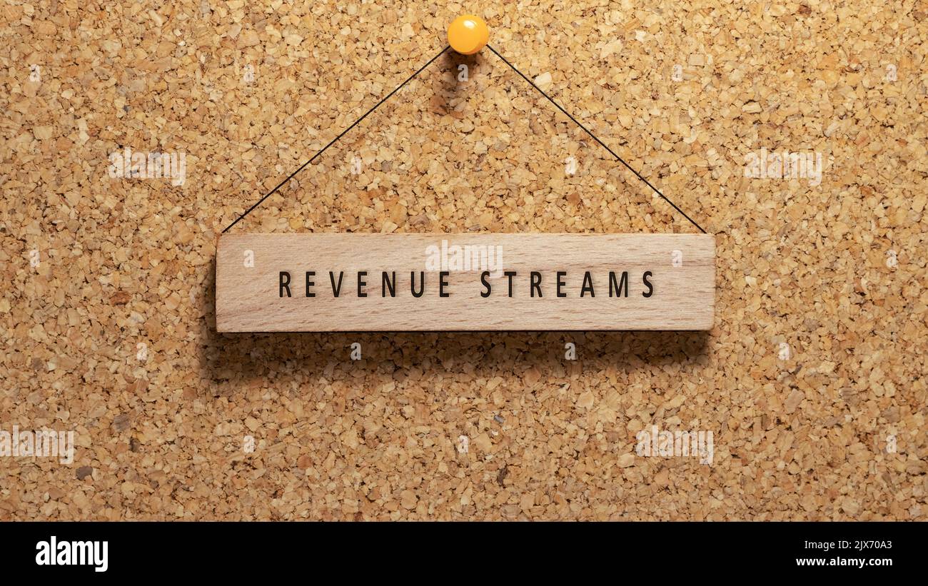 Revenue streams word written on wooden surface. Hanging on wooden board ...